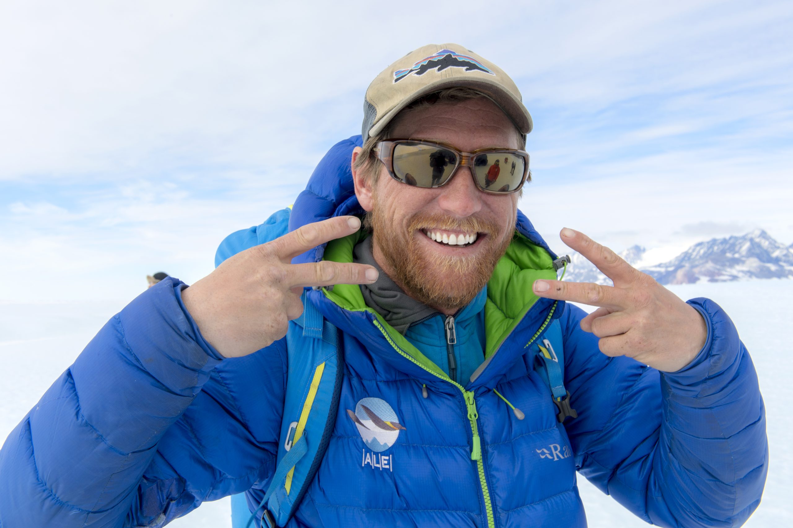 Guide Larry H. holds up peace sign fingers and smiles. - Antarctic ...