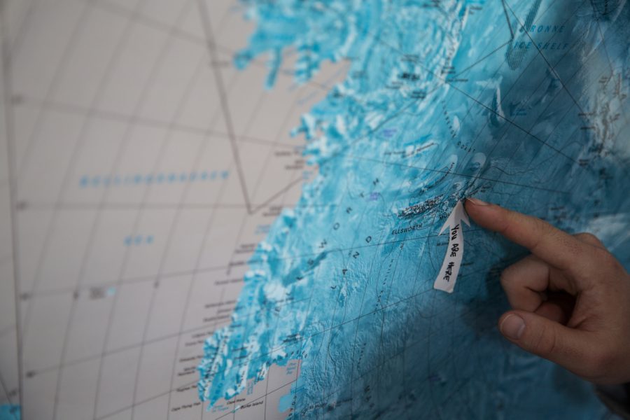 Finger points to the location of Union Glacier, on a map of Antarctica ...